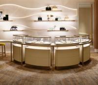 China Curved Single Jewelry Display Showcase LED | Cream Color Gold Metal Edging | Rounded Corner High-End Jewelry Boutique for Mall for sale