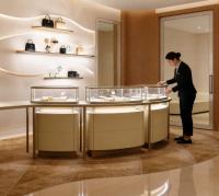 China Curved Single Jewelry Display Showcase LED | Cream Color Gold Metal Edging | Rounded Corner High-End Jewelry Boutique for Mall for sale