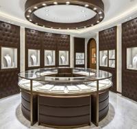 China High-End Luxury Jewelry Island Kiosk, Custom Bronze Frame & Tufted Leather Tempered Glass Showcase for Luxury Jewelry Store for sale