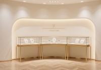 China Luxury Curved Wall-Mounted Jewelry Display Counter | Cream Body Gold Trim | Glass Showcase LED Lights for Luxury Shopping Malls for sale