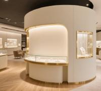 China Luxury Curved Island Jewelry Display Counter for Mall Use | Cream Body Gold Trim | Glass Showcase LED Lighting | Customizable for sale