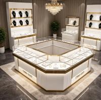 China Commercial Jewelry Display Stand Multi-Layer Glass Door Stainless Steel Brass Wood Construction LED Lighting Retail Store for sale