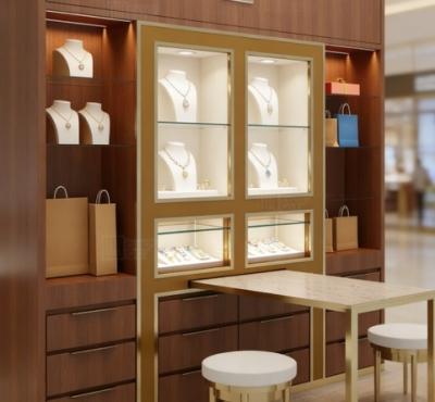 China Luxury LED Lit Wall Mounted Jewelry Display Cabinet with Wood & Gold Metal Frame Glass Showcase and Storage Drawers for sale