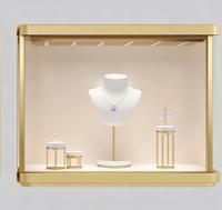 China Light Luxury Customized Wall Mounted Jewelry Showcase Champagne Gold Stainless Steel Glass Wall Cabinet LED Light Showroom for sale