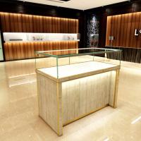 China Stone Veneer Jewellery Display Table Gold Metal Frame LED Light Glass Top Rectangular Jewelry Showcase Counter Display Case for sale