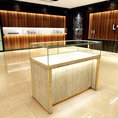 China Stone Veneer Jewellery Display Table Gold Metal Frame LED Light Glass Top Rectangular Jewelry Showcase Counter Display Case for sale