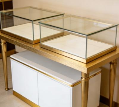 China Luxury Gold Frame Glass Jewelry Display Case with White Leather Base LED Lighting for Retail Stores & Luxury Malls for sale
