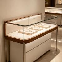 China White And Gold Color Scheme Modern Jewelry Shop Interior with Textured Wallpaper and LED Spotlights for sale