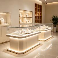 China Solid Wood Island Display Cabinet with Stainless Steel Durable Base and Curved Island Design for Retail Spaces for sale