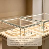 China Solid Wood Island Display Cabinet with Stainless Steel Durable Base and Curved Island Design for Retail Spaces for sale