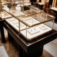 China Jewelry Shop Design with Ample Hidden Cabinets and Calacatta Marble Top in White and Gold Color Scheme for Jewelry Store Interior for sale