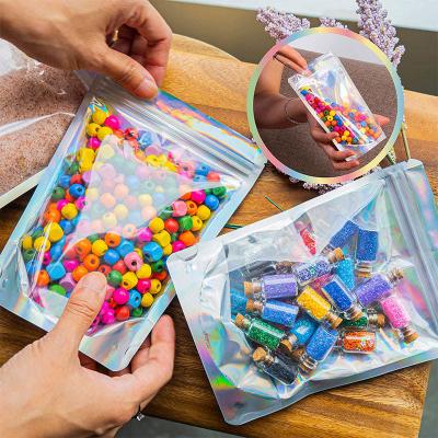 China Clear Front Foil Back Iridescent Food Zip Lock Bags Resealable Holographic Stand Up Pouches Smell Proof Mylar Bags for sale