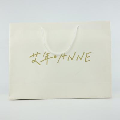 China Custom Kraft Paper Shopping Bags with Logo 80-300gsm Foldable Reusable for sale
