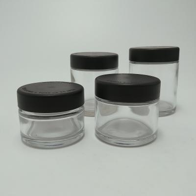 China 3oz Childproof Clear Glass Jar with Push and Screw Cap for Herbs Flowers CBD Storage for sale
