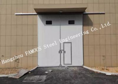China Sectional Horizontal Sliding Industrial Garage Doors With Access Pedestrian Door For Workshop for sale