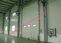 China Full Vertical Lift Door Motorized Industrial Garage Doors With Transparent Windows And Pedestrian Access for sale