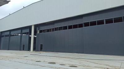 China Engineered Unidirectional Aeronautical Hangar Door Typical Design With Wicket for sale
