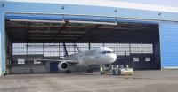 China Single Bay PEB Steel Aircraft Hangar with Electrical Roll-up Doors - H-Style Steel Frame & Custom Panel Options for sale