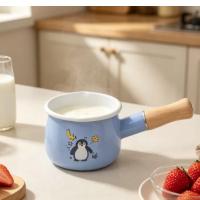 China Pastel Blue Cute Penguin Print Enamel Milk Pot With Wooden Heatproof Handle Small Enamel Saucepan For Heating Milk Baby Food for sale