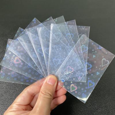 China 2025 New Arrival Flashing Transparent Self Adhesive Game Photo Plastic Card Sleeves Trading Card Protection for sale