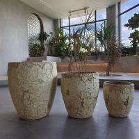 China Fiber Clay Planter Hand Carved Frost Resistant Round Flower Pot 52 lbs Light Yellow for sale