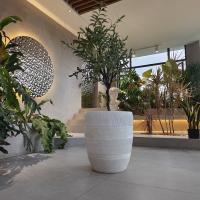 China Fiber Clay Planter Round Hand Carved Texture Frost Resistant 10-30 Inch Indoor Outdoor for sale