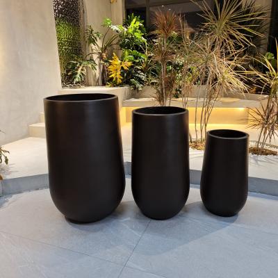 China Round Fiber Clay Planter Hand Carved Frost Resistant 5-6 Years Outdoor Flower Pot for sale