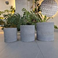 China Quangui Fiber Clay Planter Hand Carved Round D450 H450 with Drainage Holes for sale