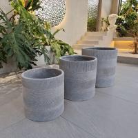 China Quangui Fiber Clay Planter Hand Carved Round D450 H450 with Drainage Holes for sale