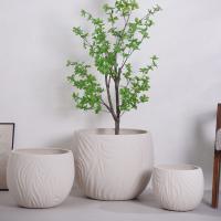 China Irregular Wavy Lines Pattern Neutral Beige Round Fiber Clay Planter for sale