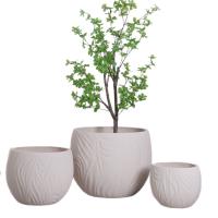 China Irregular Wavy Lines Pattern Neutral Beige Round Fiber Clay Planter for sale