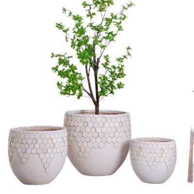 China Prosperity Honeycomb Structure Pattern Neutral Beige Round Fiber Clay Planter Decoration for sale