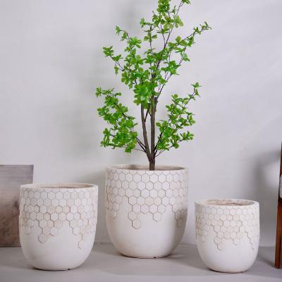 China Natural Honeycomb Pattern Neutral Beige Round Lightweight Fiber Clay Planter for sale