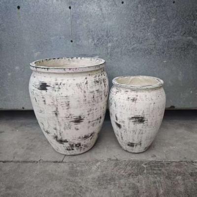 China Irregular Black Brush White Round Fiber Clay Planter Lobby Redesign for sale
