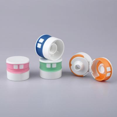 China TPE Soft Touch 35mm Diameter Two Color Children Tooth Paste Flip Cap for sale