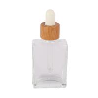 China 30ml 50ml 100ml Square Clear Glass Dropper Bottle Eco Friendly Bamboo Essential Oil Bottle for sale