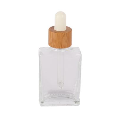 China 30ml 50ml 100ml Square Clear Glass Dropper Bottle Eco Friendly Bamboo Essential Oil Bottle for sale