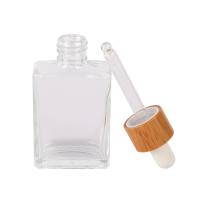 China 30ml 50ml 100ml Square Clear Glass Dropper Bottle Eco Friendly Bamboo Essential Oil Bottle for sale