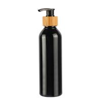 China Black Round Shoulder Cosmetic Lotion Bottle Bamboo PET Bottle 180ml 200ml 250ml 300ml for sale