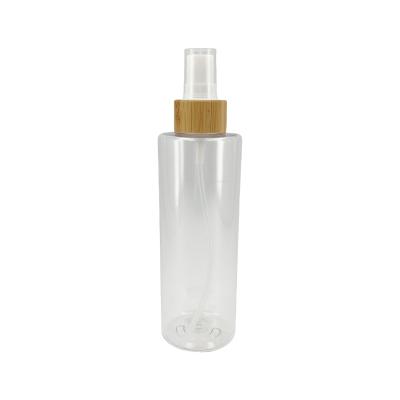 China Round Flat Shoulder Transparent Plastic Perfume Spray Bottles With Bamboo Lids 100ml 120ml for sale