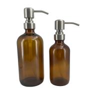 China Luxury 8oz 16oz Glass Clear Amber Boston Round Pump Bottles For Hand Lotion Shampoo for sale