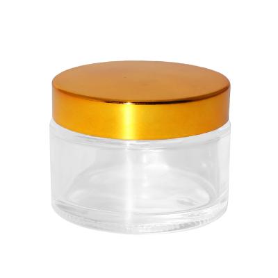 China Mirror Finish Golden Colored Lid Transparent Glass Cream Jars 30g Portable Cosmetic Containers for sale