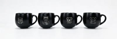 China Matte Black Round Belly Ceramic Mugs with Cute White Line Animal Prints, 4-Piece Cartoon Wildlife Coffee Cup Set for sale