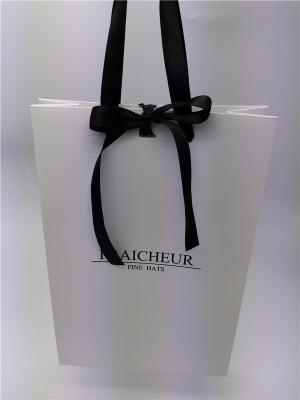 China Space saving foldable Recycled Gift Bags crafted from white art paper with customizable logo and ribbon color perfect for retail and gifting for sale