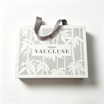China High End Recycled Gift Bags Made from Recyclable Art Paper with Bamboo Leaf Embossed Design and Satin Ribbon Handle for sale