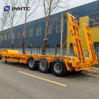 China Heavy Duty 60 80 Tons Lowbed Truck Semi Trailer With Leaf Spring Suspension System And Water Function for sale