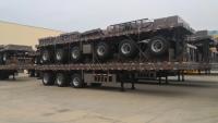 China Wholesale Customizable 100 Ton Flatbed Semi-Trailer New Condition 3-Axle Transport Container Wabco Brake System Steel Material for sale