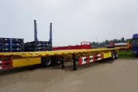 China 4-Axle Flatbed Shipping Container Semi Trailer With Nice Twistlocks Utility Steel Flatbed Semi Trailer for sale