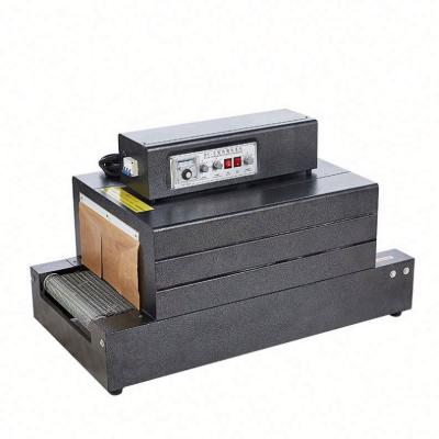China Hot Sale Small Plastic Film Heat Tunnel Shrink Cutting Packaging Machine for Bottle/box Easy Operate for sale