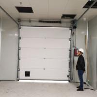 China 40mm Thickness Wind-Resistant Heat-Insulating Industrial Sectional Overhead Insulated Door for Workshops for sale